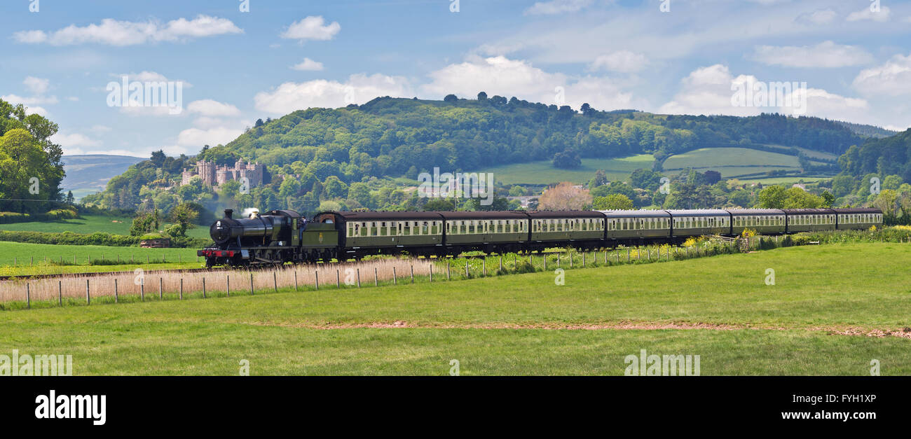 West Somerset Railways steam train 3850 passing Dunster castle with the ...