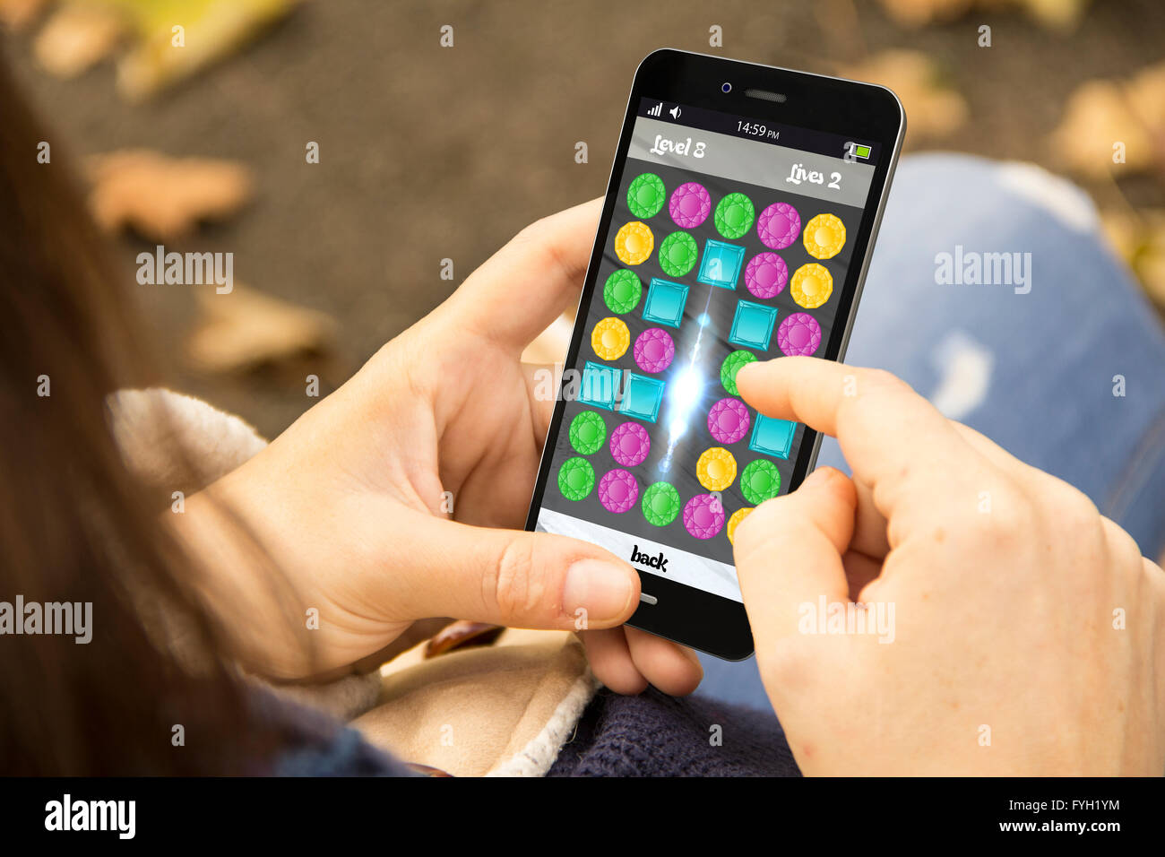 idle and gaming concept: girl playing a jigsaw game on a digital ...