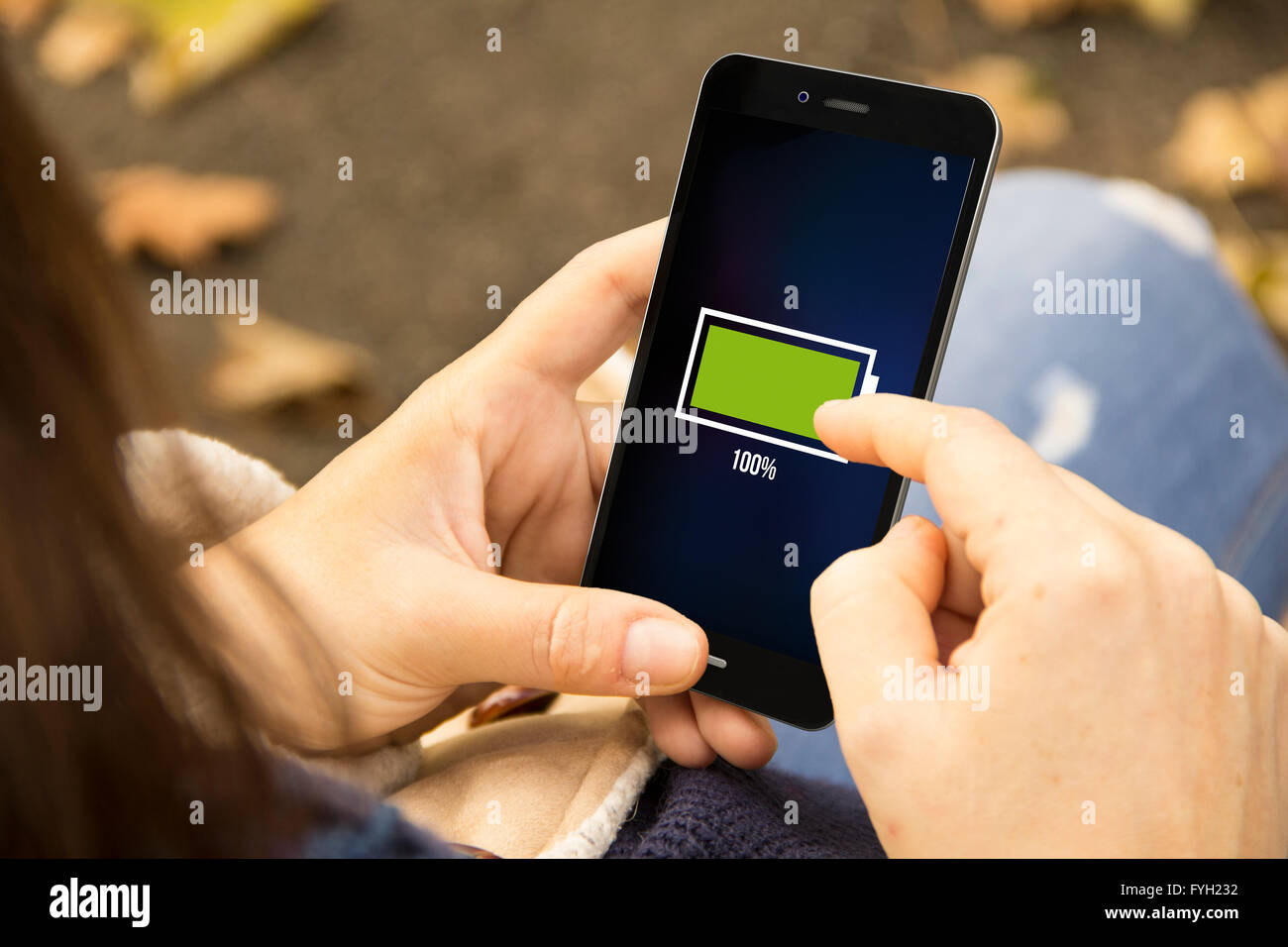 energy concept: woman holding a 3d generated smartphone with full ...