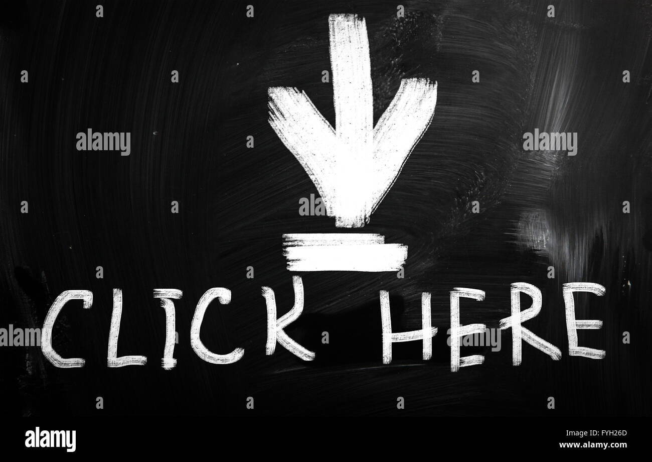 Click here handwritten with white chalk on a blackboard Stock Photo - Alamy