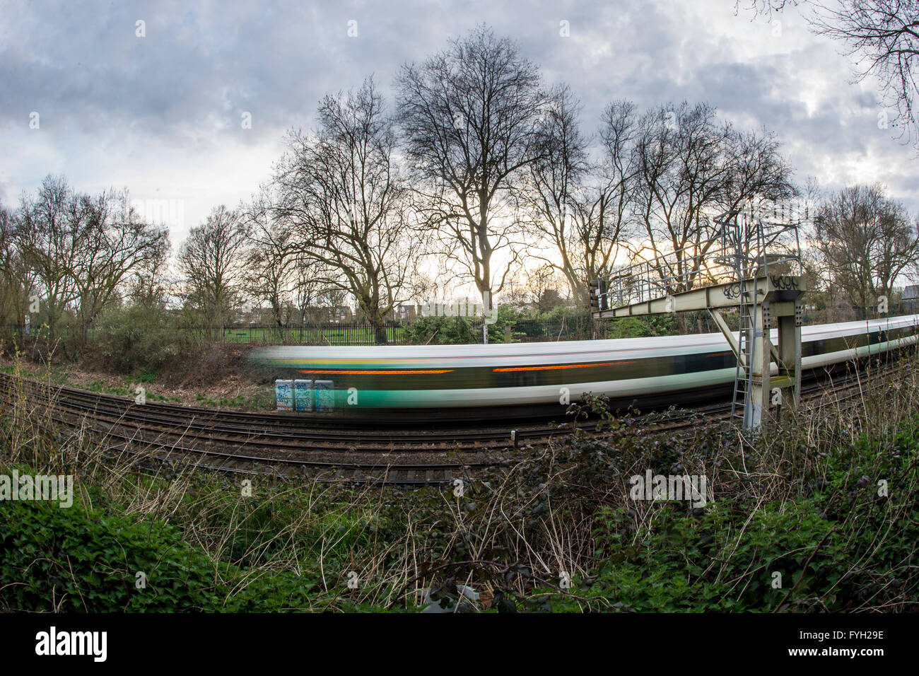 Road bollards and general rubbish on a train track with a train ...