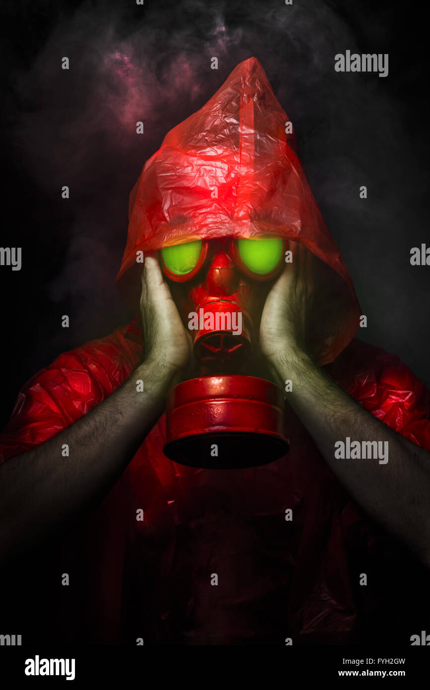 Toxic military concept, man with red gas mask Stock Photo - Alamy