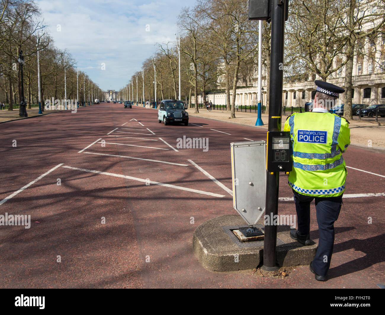 A policeman checks for speeding cars on the Mall in central London ...