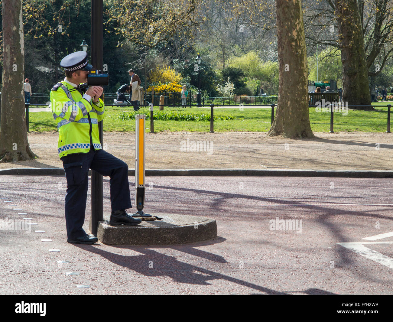 A policeman checks for speeding cars on the Mall in central London ...