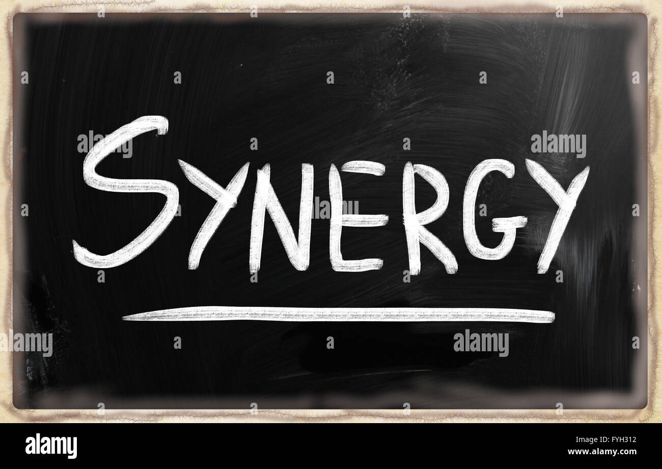 The word Synergy handwritten with white chalk on a blackboard Stock ...