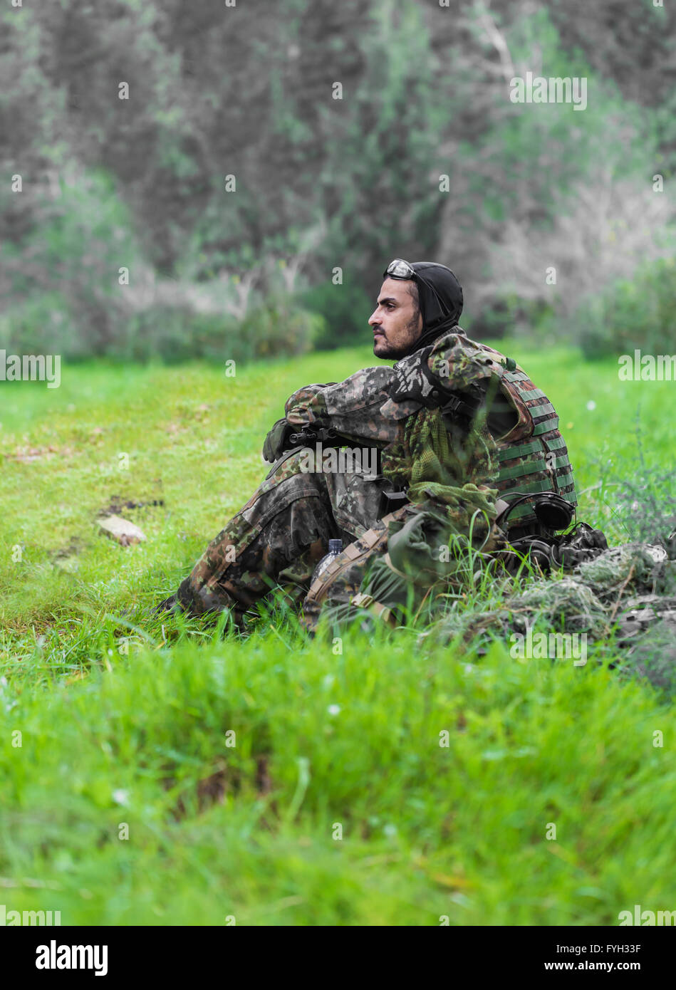 man in military uniform sitting on the grass Stock Photo - Alamy