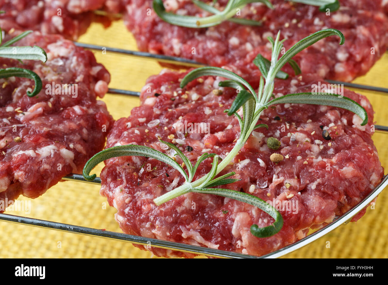 Raw minced hamburger meat with herb and spice prepared for grilling ...
