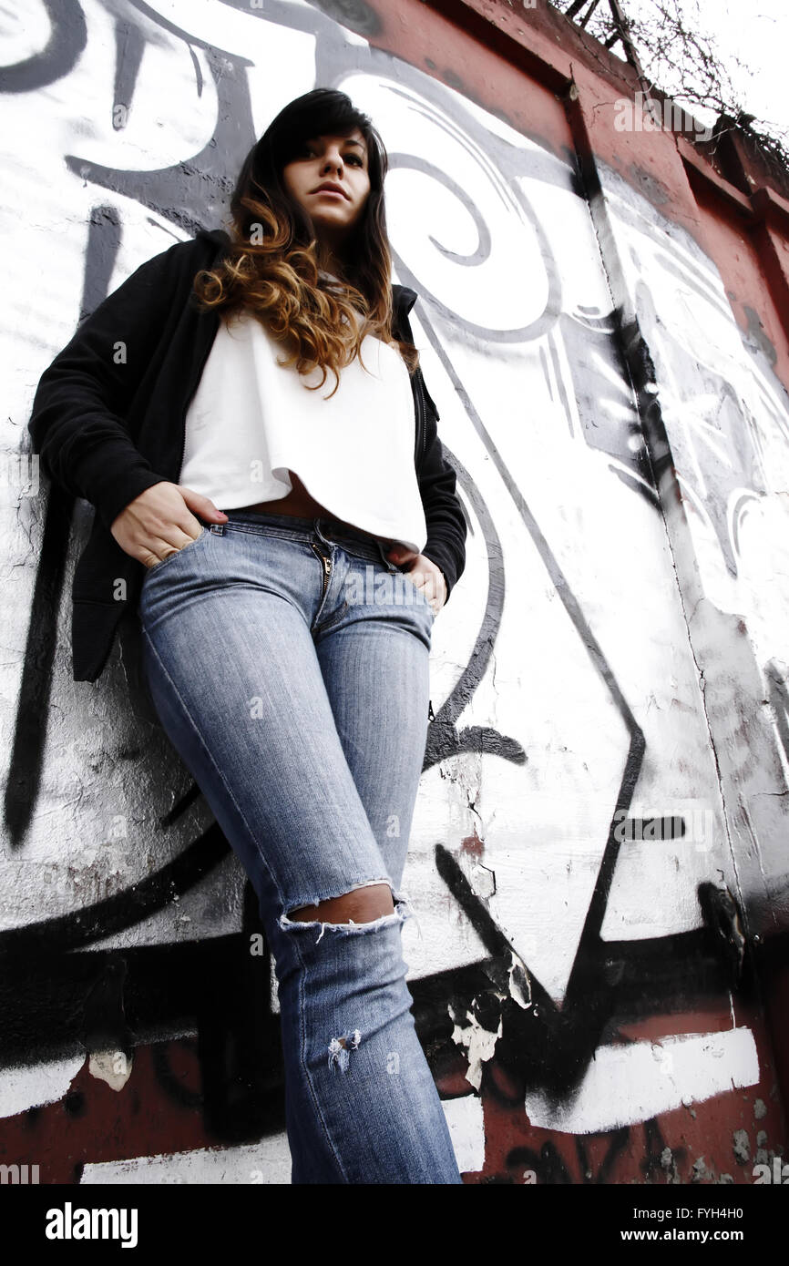 Girl leaning on a Wall Stock Photo - Alamy