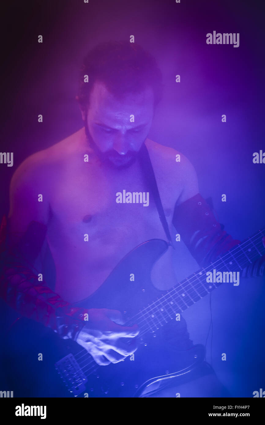 Rock star playing solo on guitar, neon lights Stock Photo - Alamy