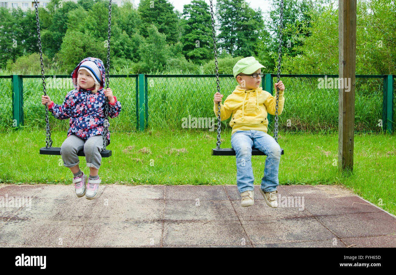 Two children fun swinging on hi-res stock photography and images - Alamy