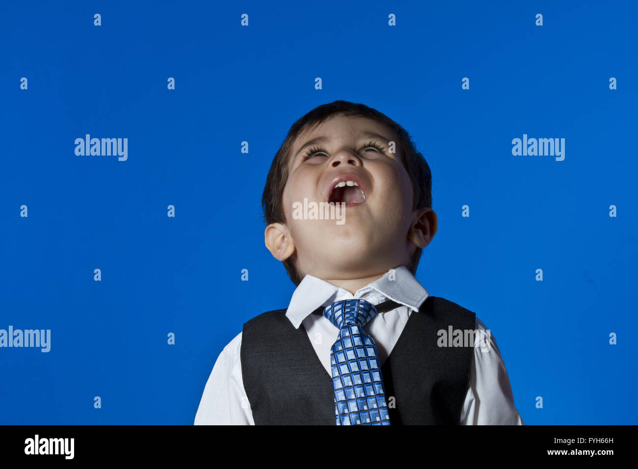 Leader, cute little boy portrait over blue chroma background Stock ...