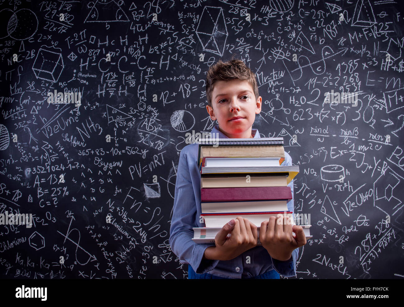 Boy with books against big blackboard with mathematical symbols Stock ...