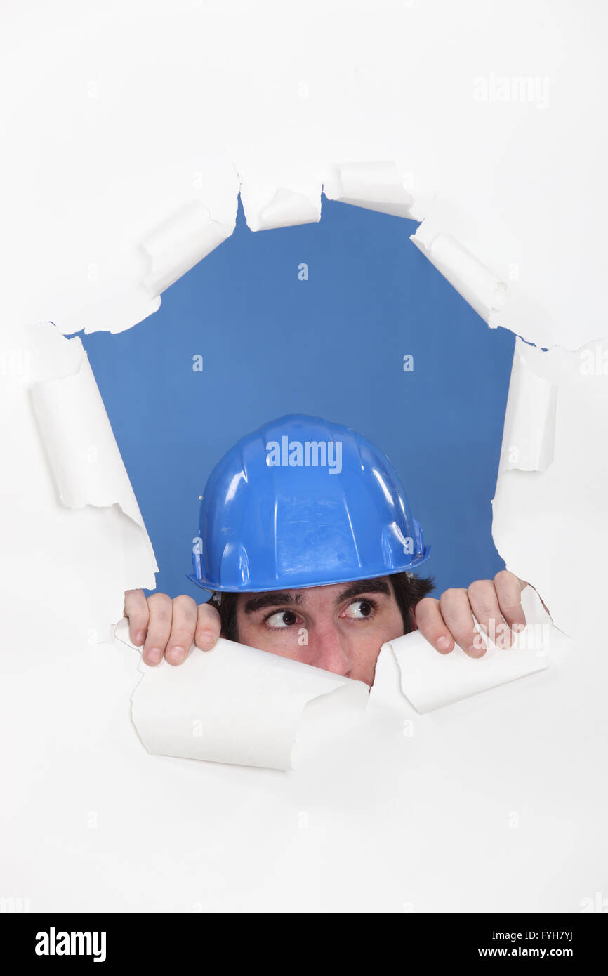 Peeking through the wall hi-res stock photography and images - Alamy