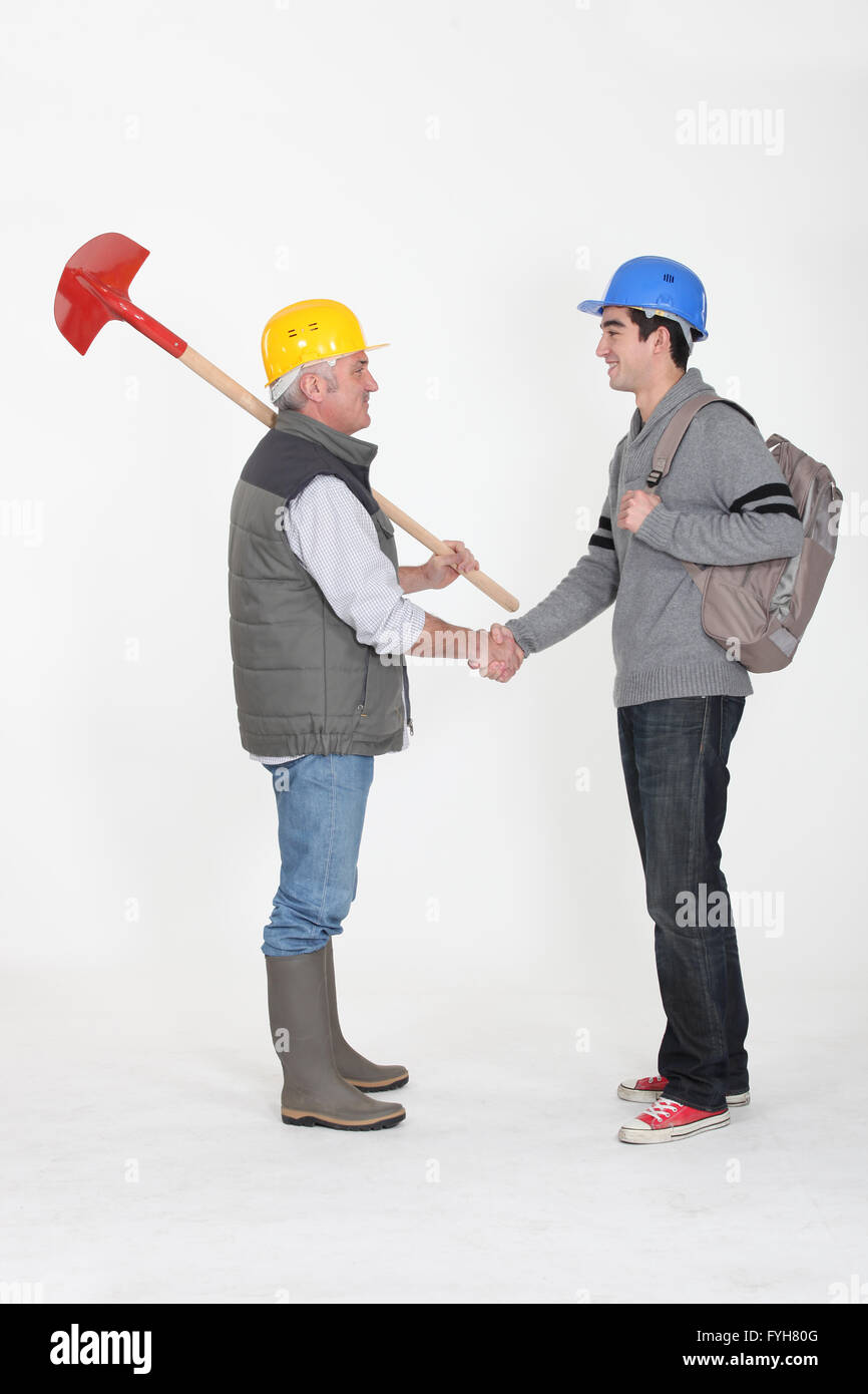 Experienced tradesman meeting his new apprentice Stock Photo - Alamy