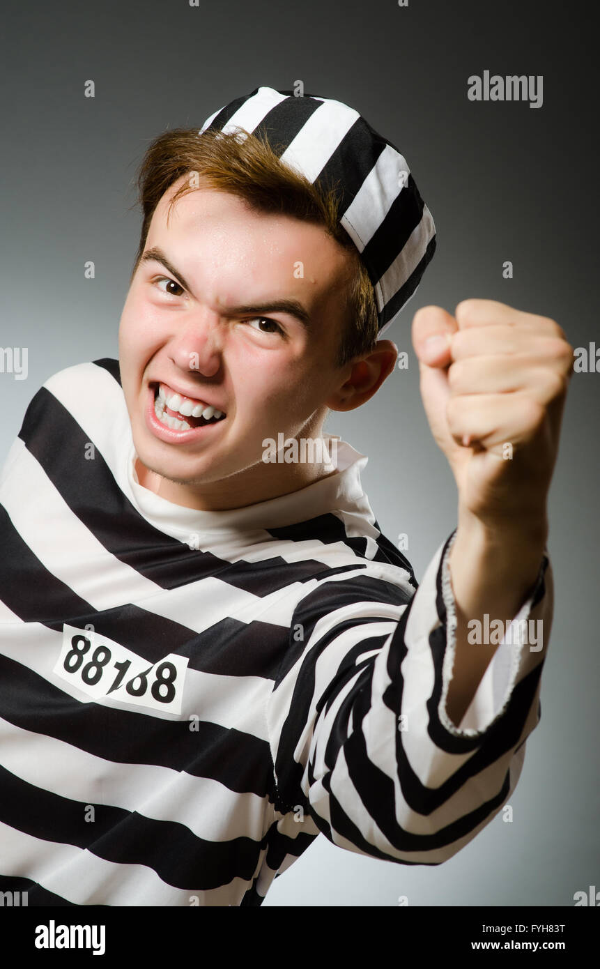 Funny prisoner in prison concept Stock Photo - Alamy