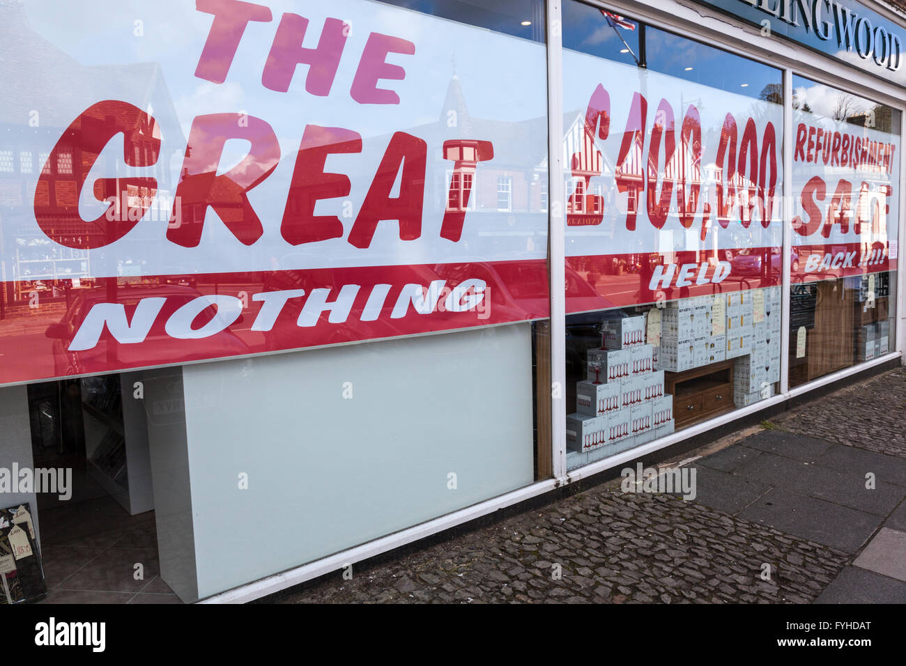Big red posters in a shop window advertise a forthcoming sale Stock ...