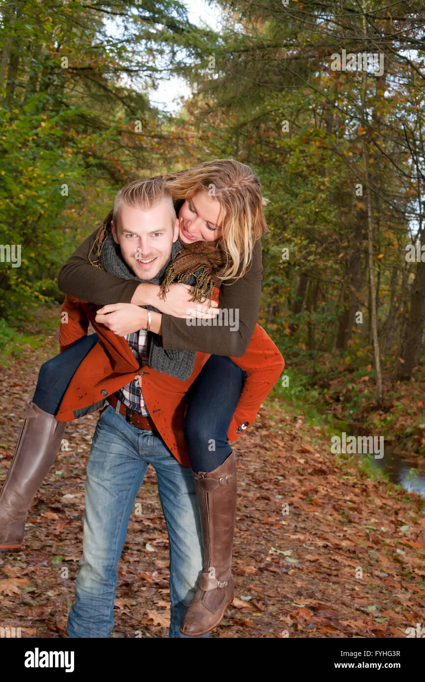 Young couple is riding piggyback Stock Photo - Alamy