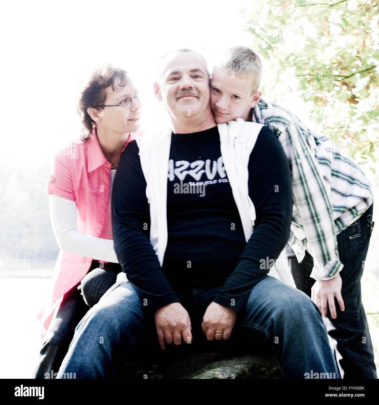 Happy family kiss Stock Photo - Alamy