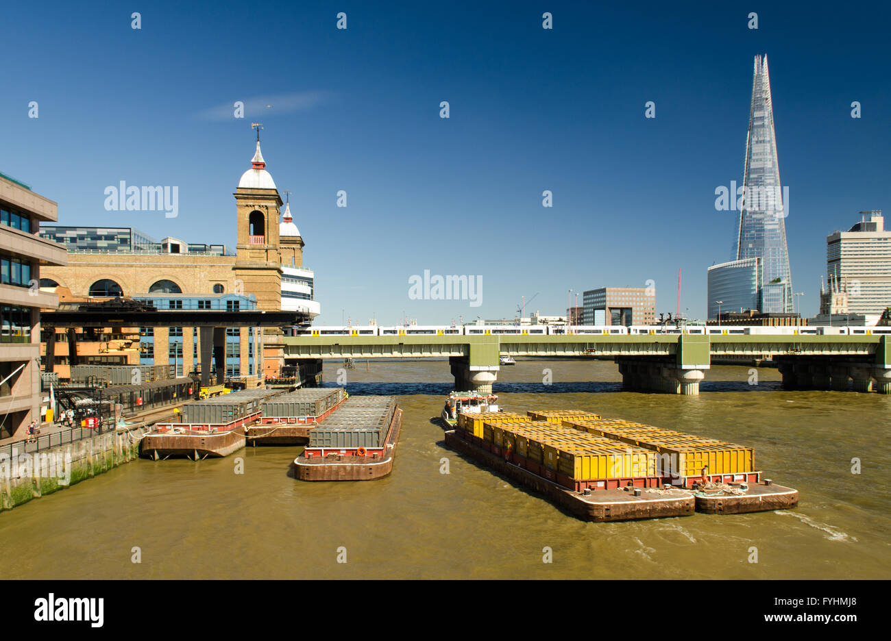Barges are loaded with freight containers containing refuse from the ...