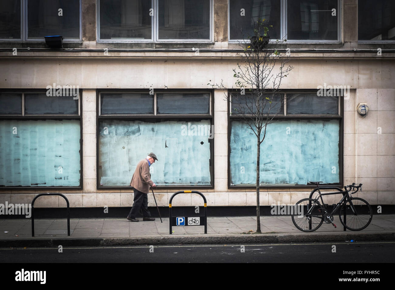 Old man in a London street outside closed shop Stock Photo - Alamy