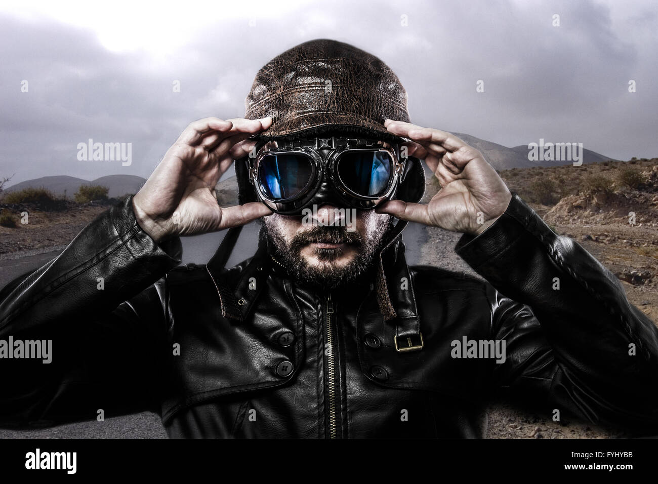 Speed biker with black leather jacket and old glasses Stock Photo - Alamy