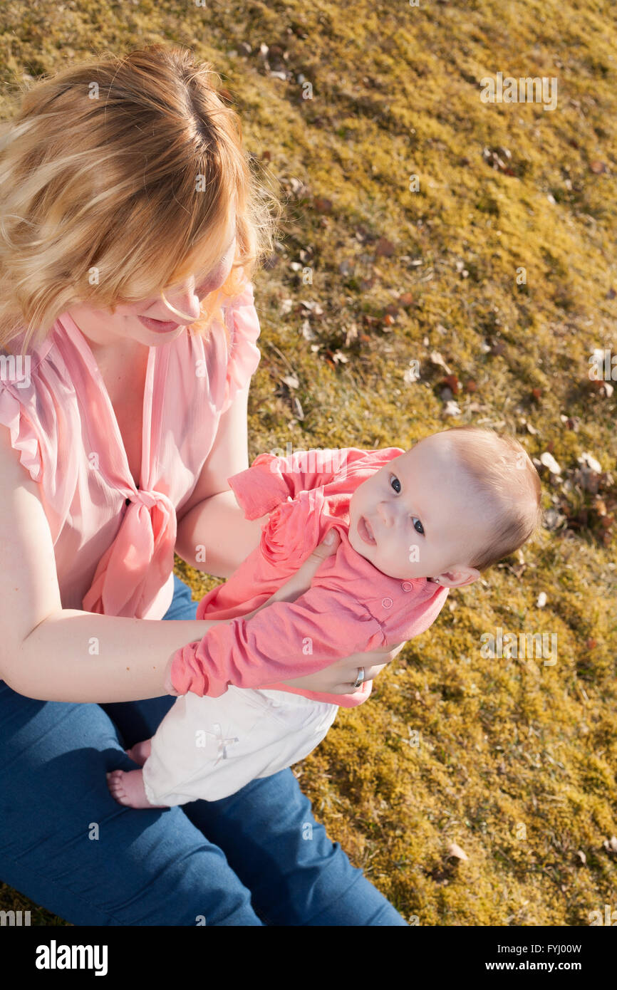 Mother is helping her baby standing Stock Photo - Alamy