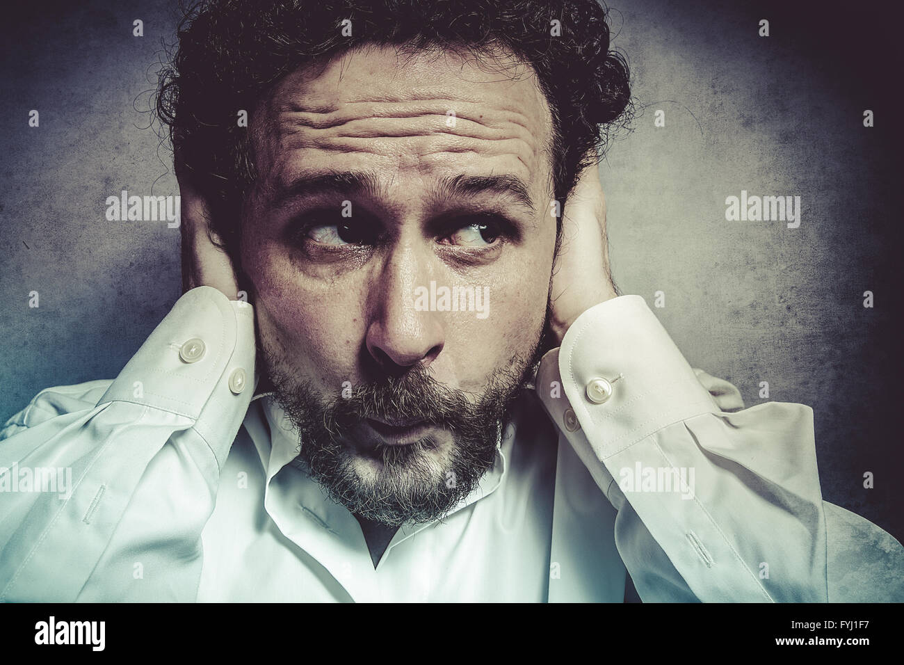 Businessman covering his ears, man in white shirt with funny ...