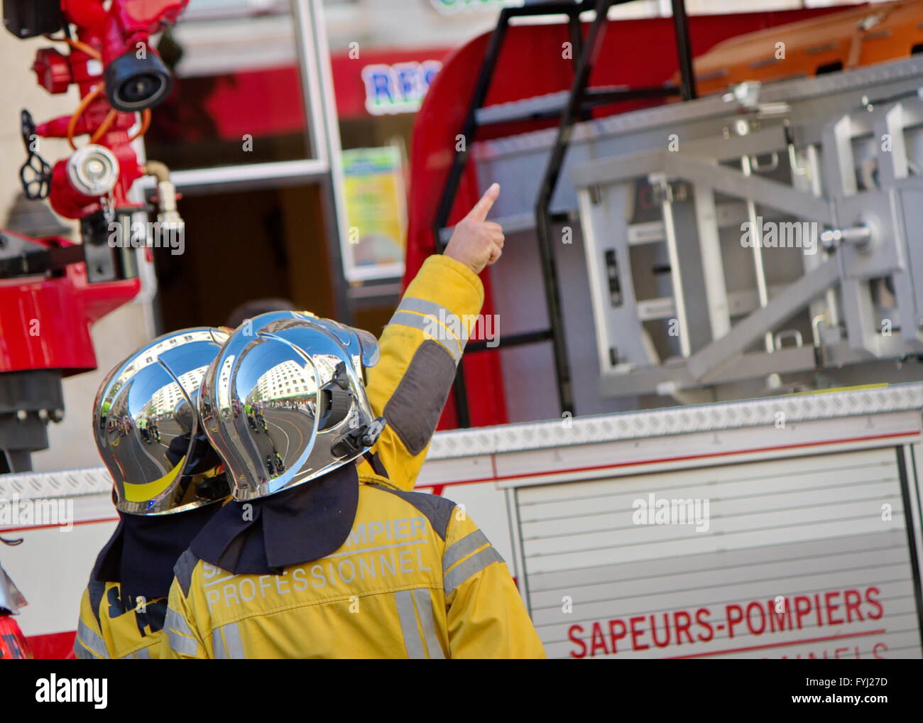 Firefighters discussing next to fire truck, Geneva, Switzerland Stock ...