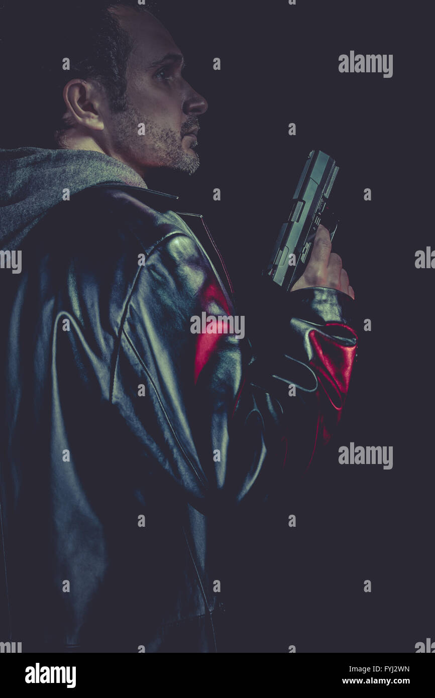 Lone man armed with a pistol, robber Stock Photo - Alamy