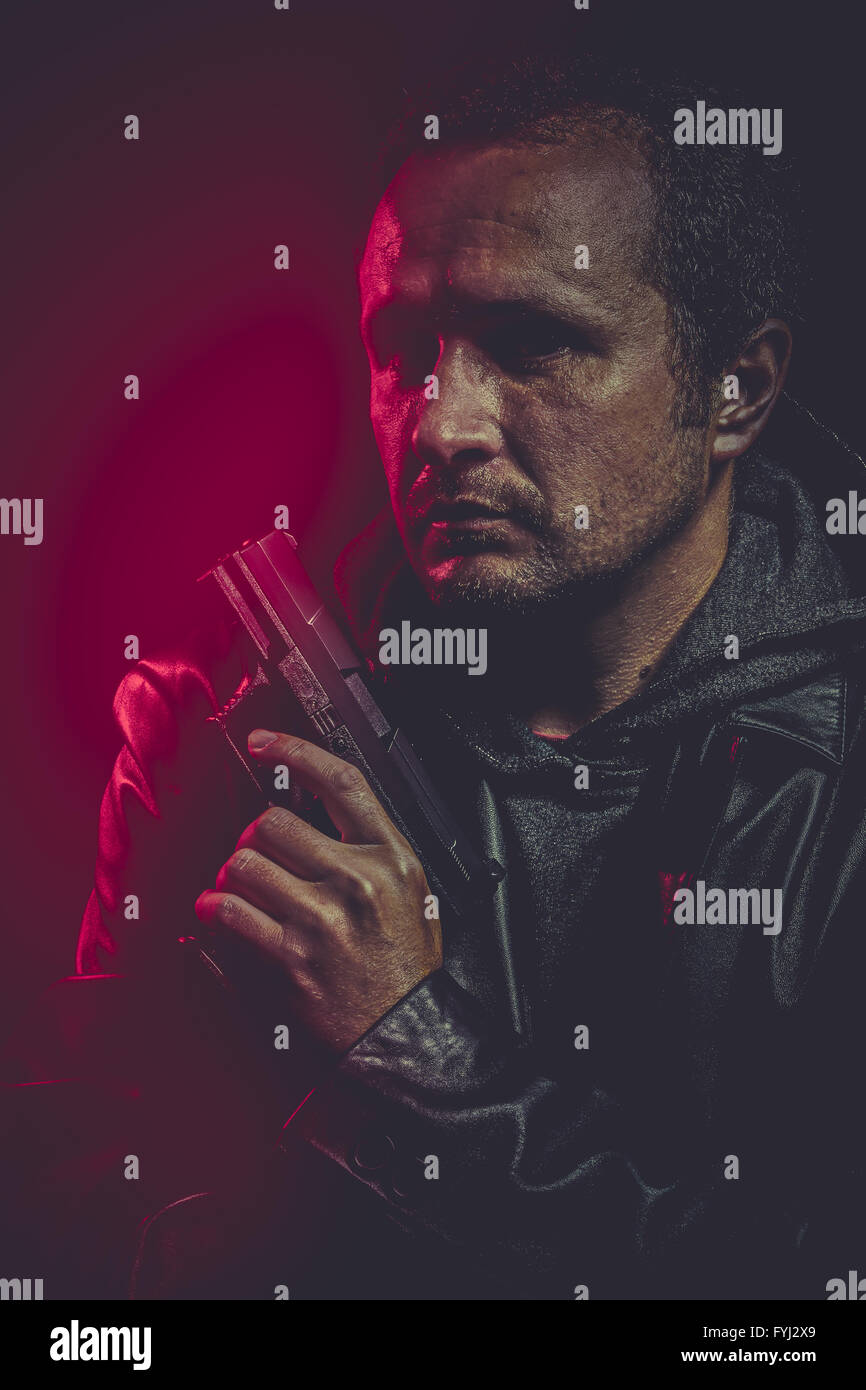 Robber with gun over red background Stock Photo - Alamy
