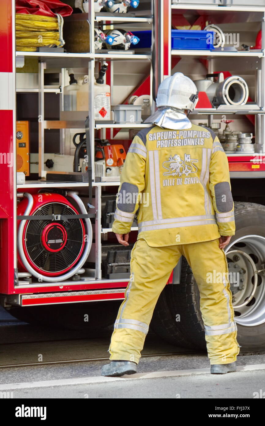 Firefighter discussing next to fire truck, Geneva, Switzerland Stock ...