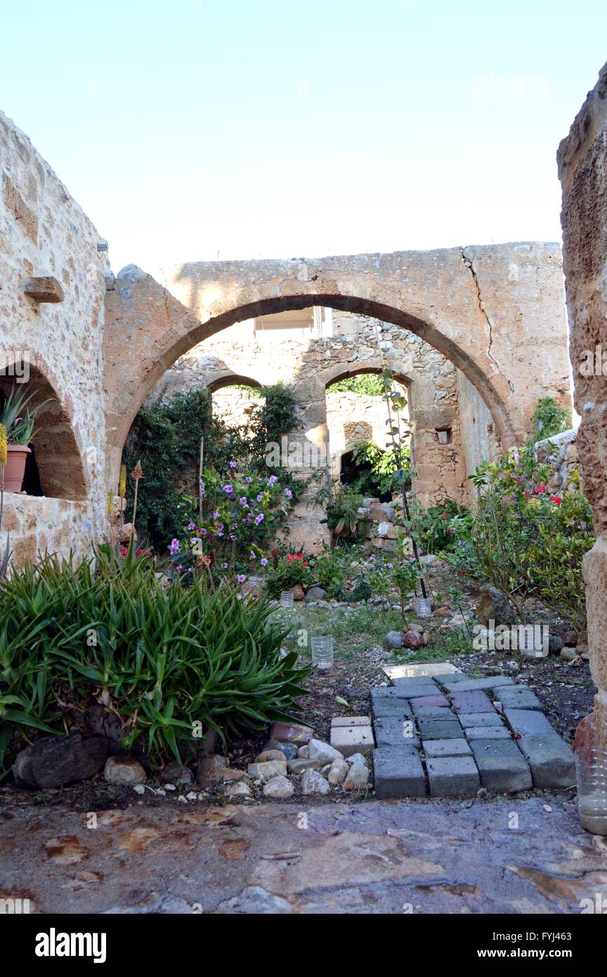 Ruins in stones to transform into garden growing green with flowers and ...
