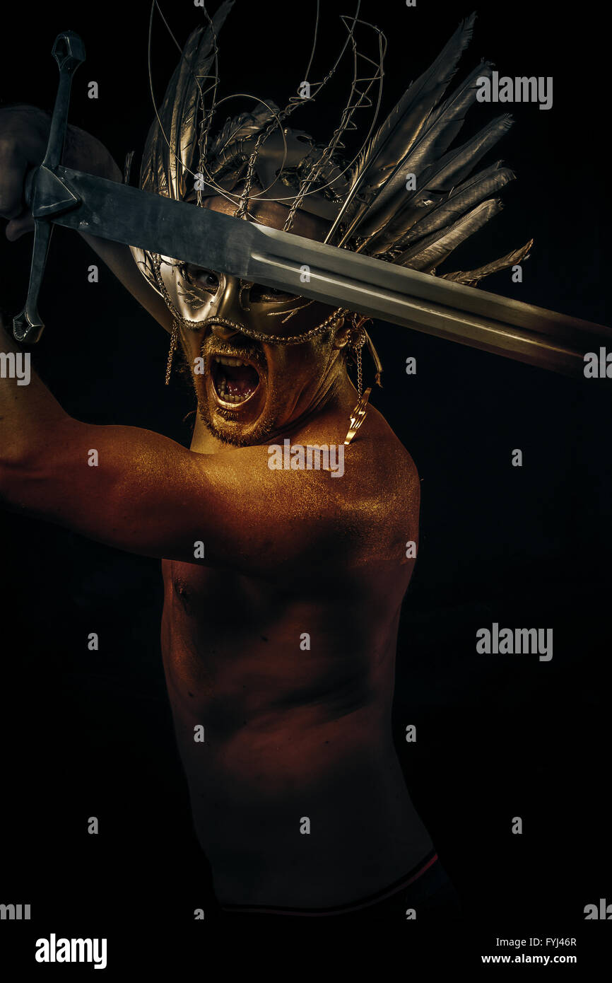 Courage, warrior or ancient god with golden mask and sword greatsword ...