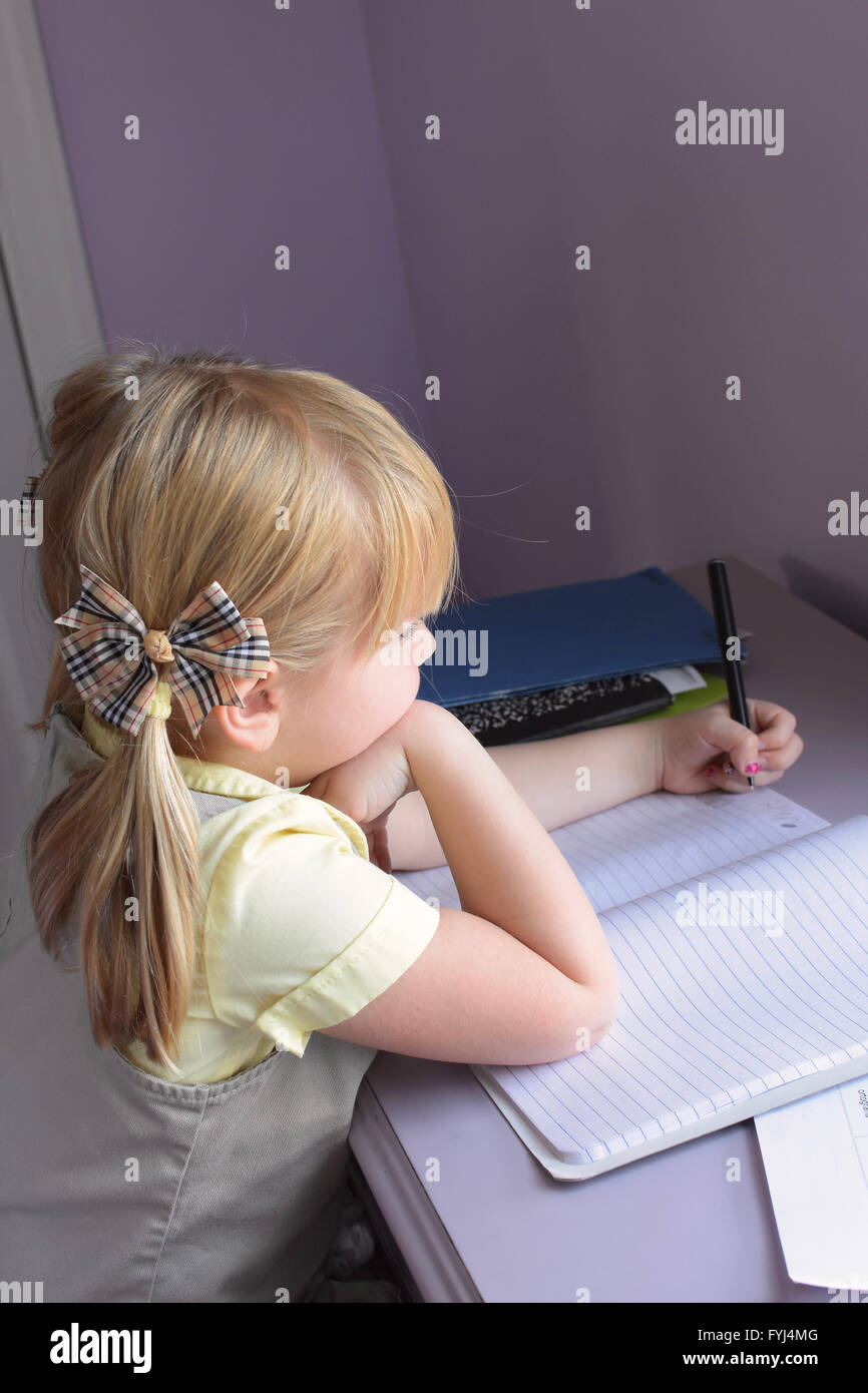 young girl child doing homework Stock Photo - Alamy