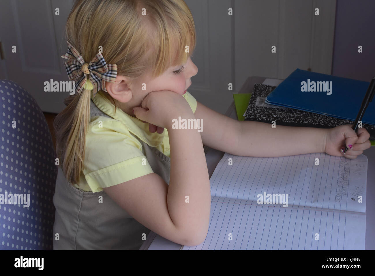 young girl child doing homework Stock Photo - Alamy