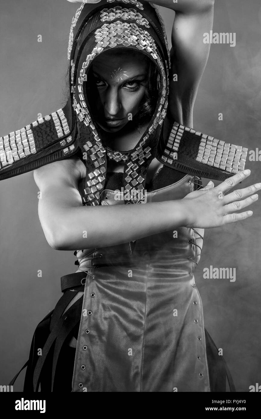 Strong dance, Beautiful brunette woman in armor formed by mirrors Stock ...