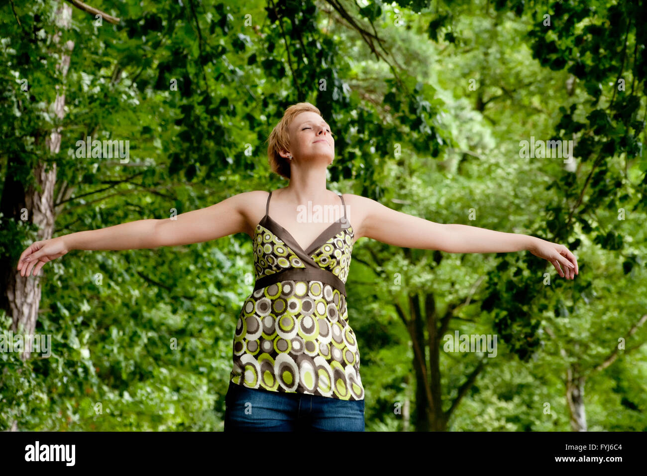 blond girl flying in the forest Stock Photo - Alamy