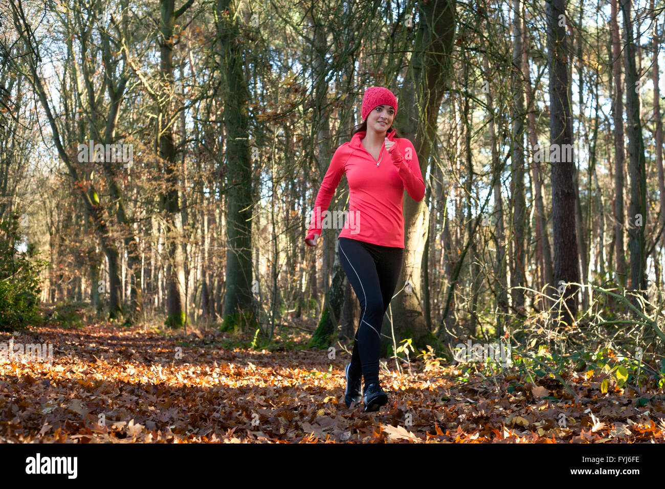 Woman athlete running in forest hi-res stock photography and images - Alamy