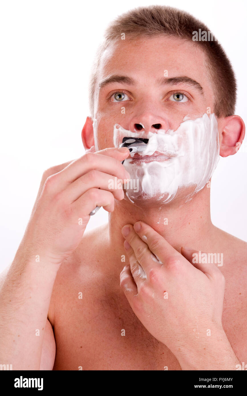 Young man is shaving Stock Photo - Alamy