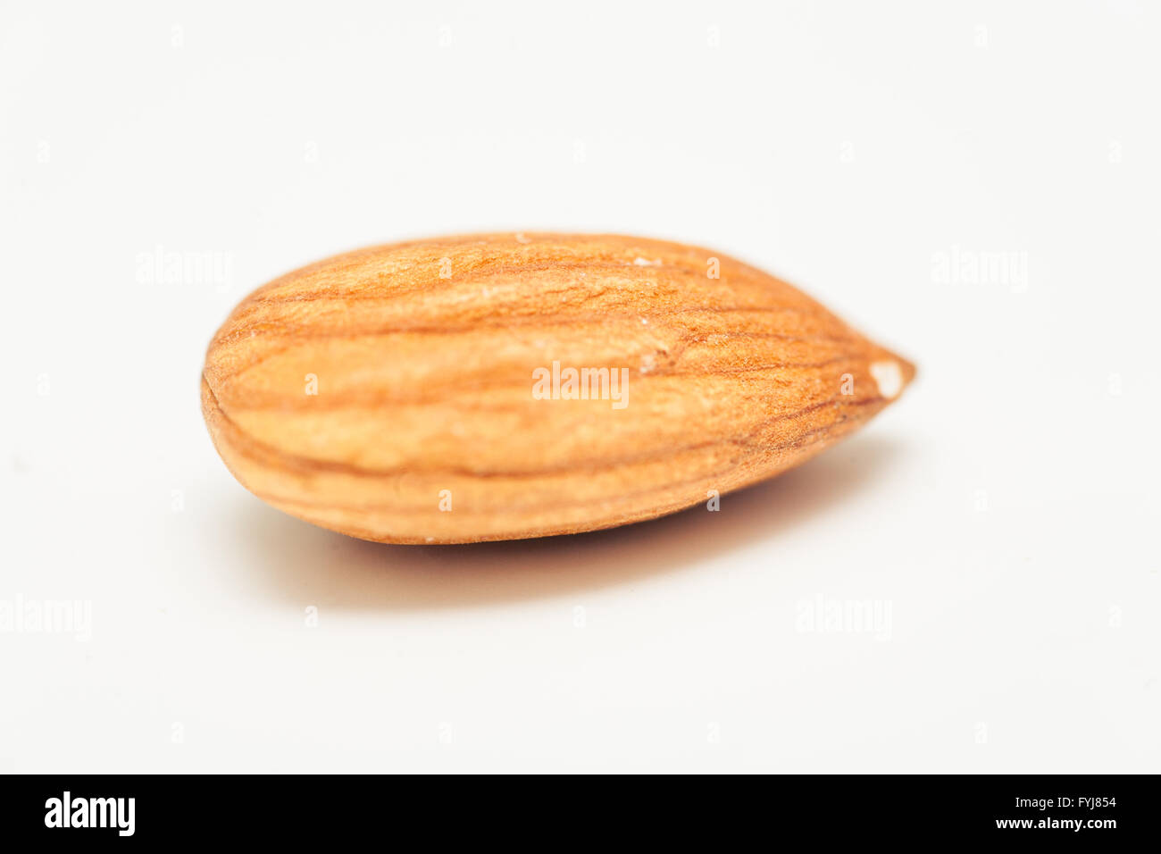 one almond closeup isolated on white background Stock Photo - Alamy