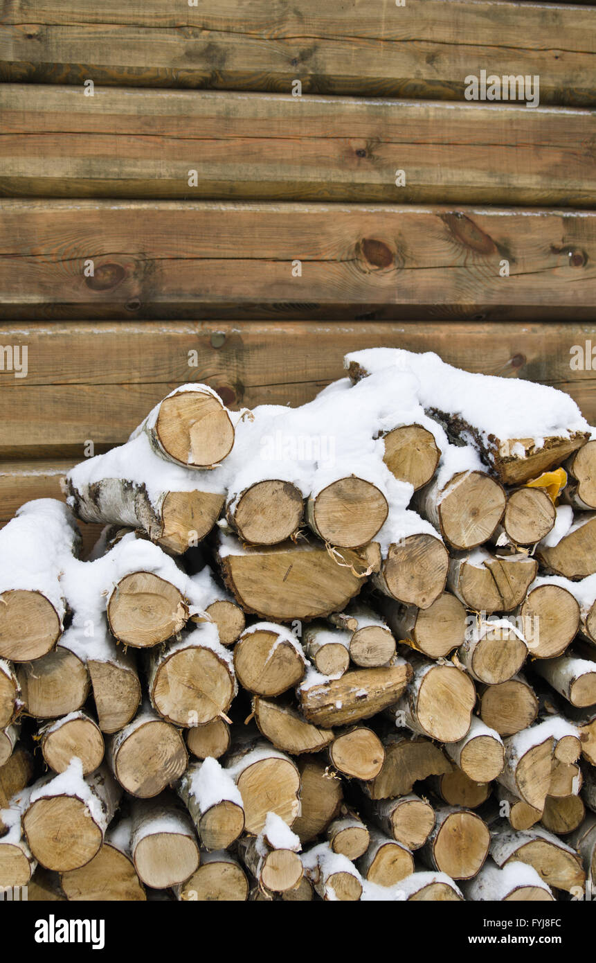 Birch fire wood at a wall of the house in winter Stock Photo - Alamy