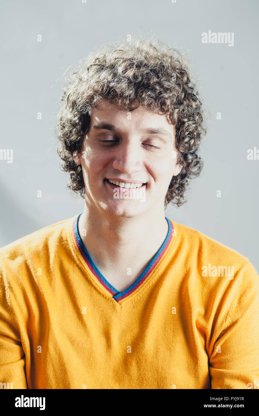 Detailed portrait of a young caucasian guy with curly hair Stock Photo ...