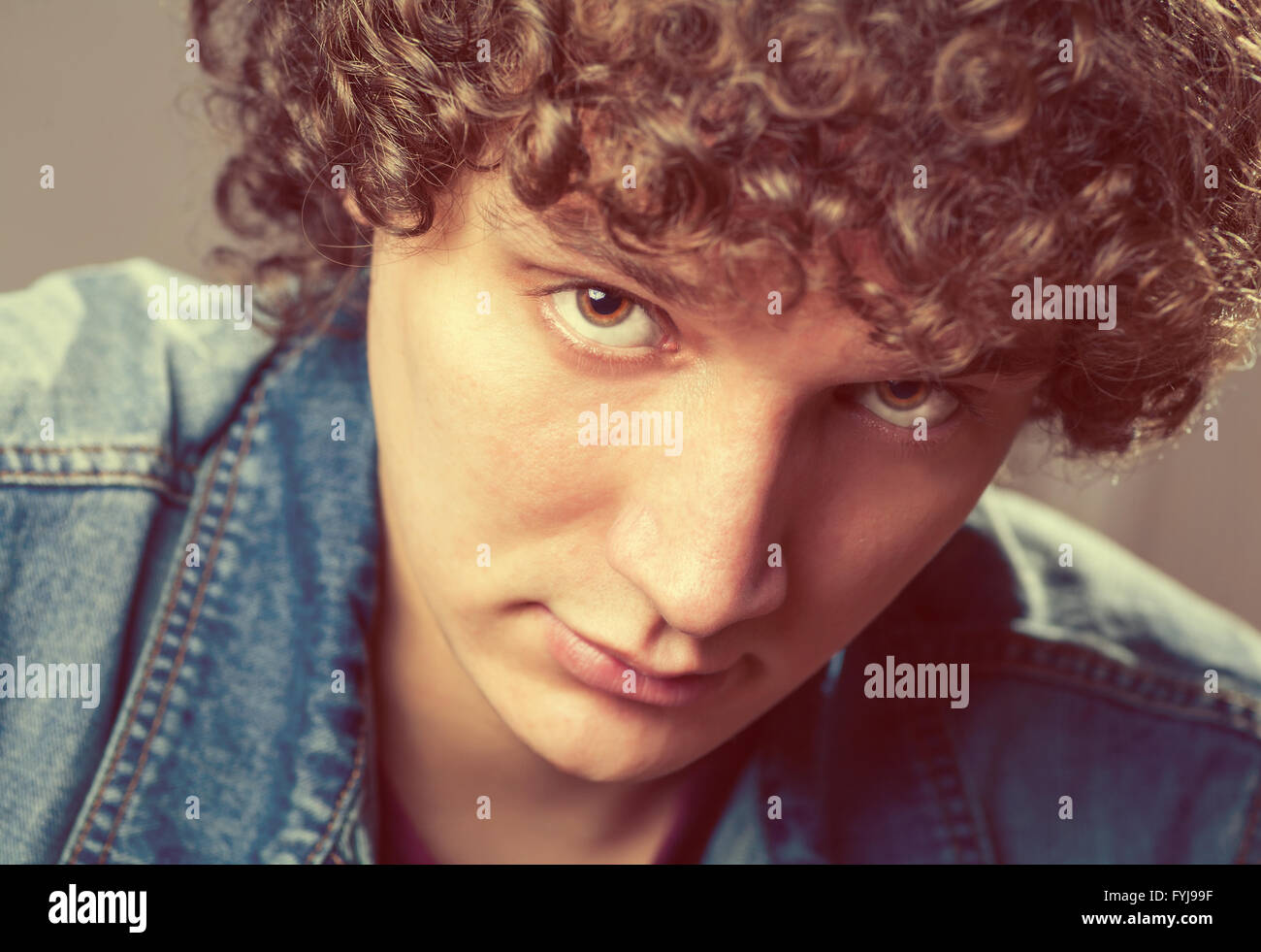 Detailed portrait of a young caucasian guy with curly hair Stock Photo ...