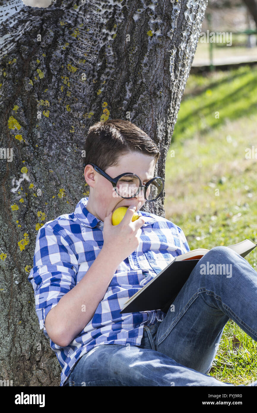 Boy lying in a park and reading a book hi-res stock photography and ...