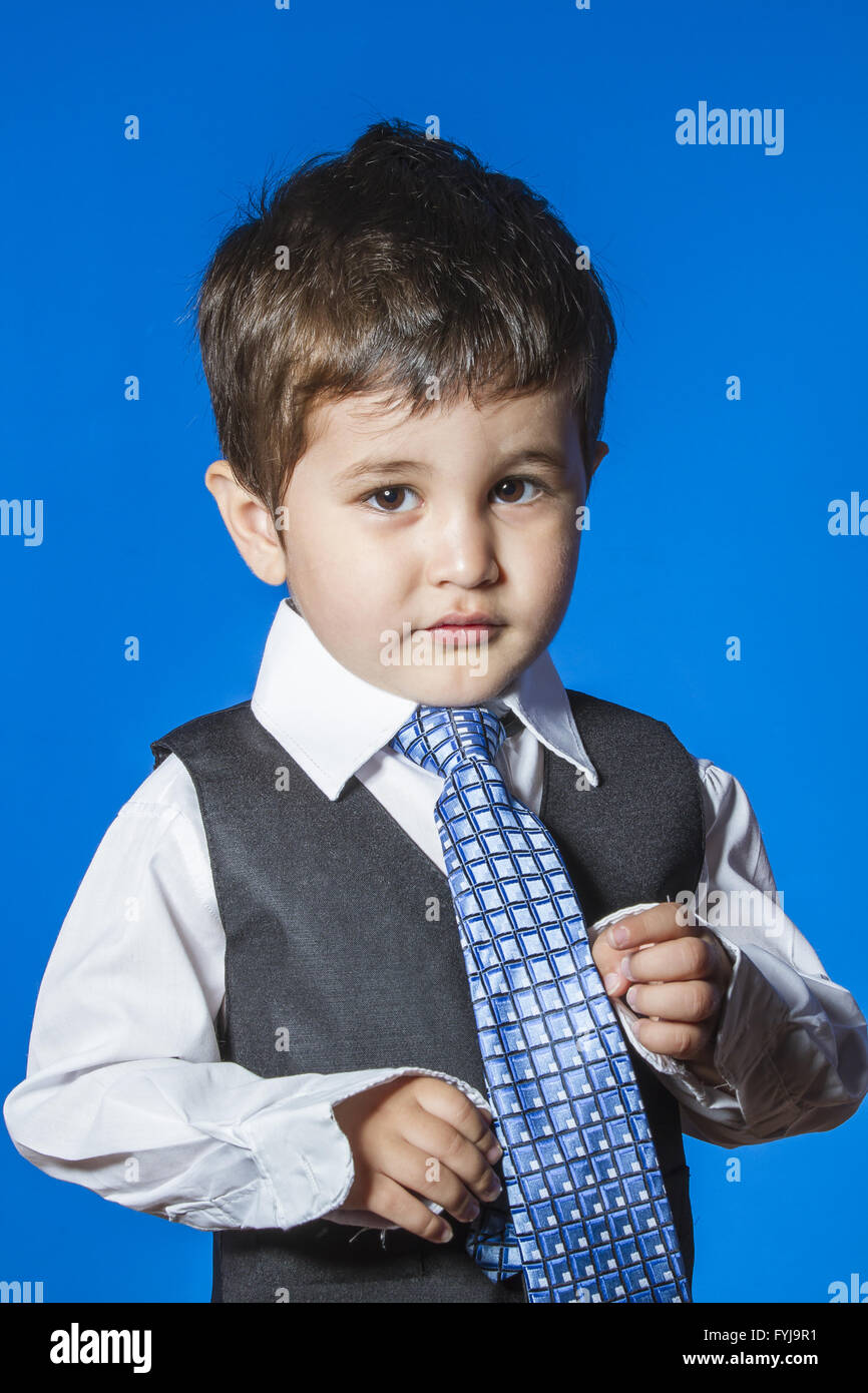 Leader, cute little boy portrait over blue chroma background Stock ...