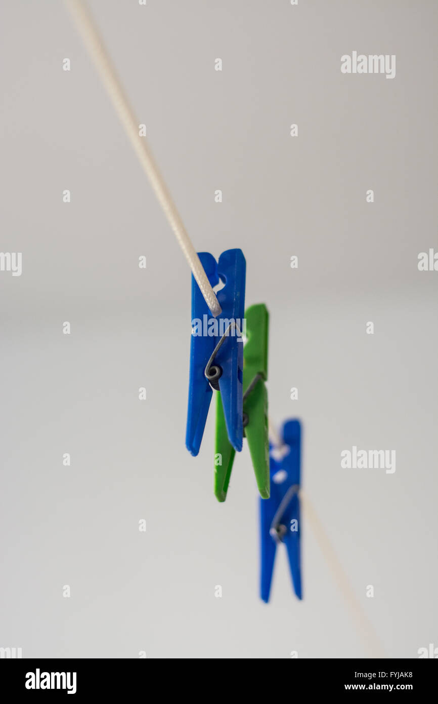 Colored clips in a rope line Stock Photo - Alamy