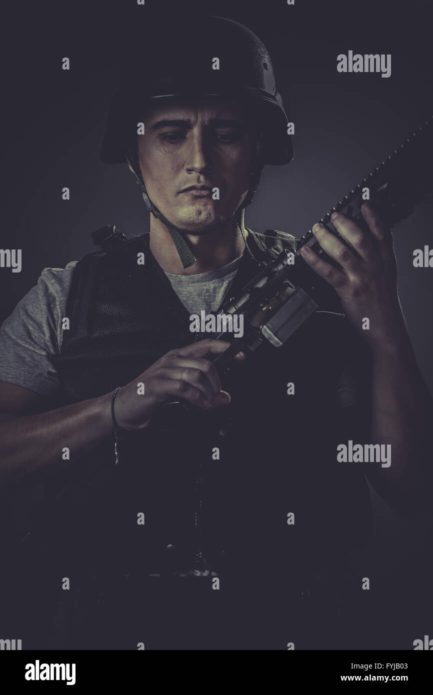 Air-soft, paintball sport player wearing protective helmet aiming ...