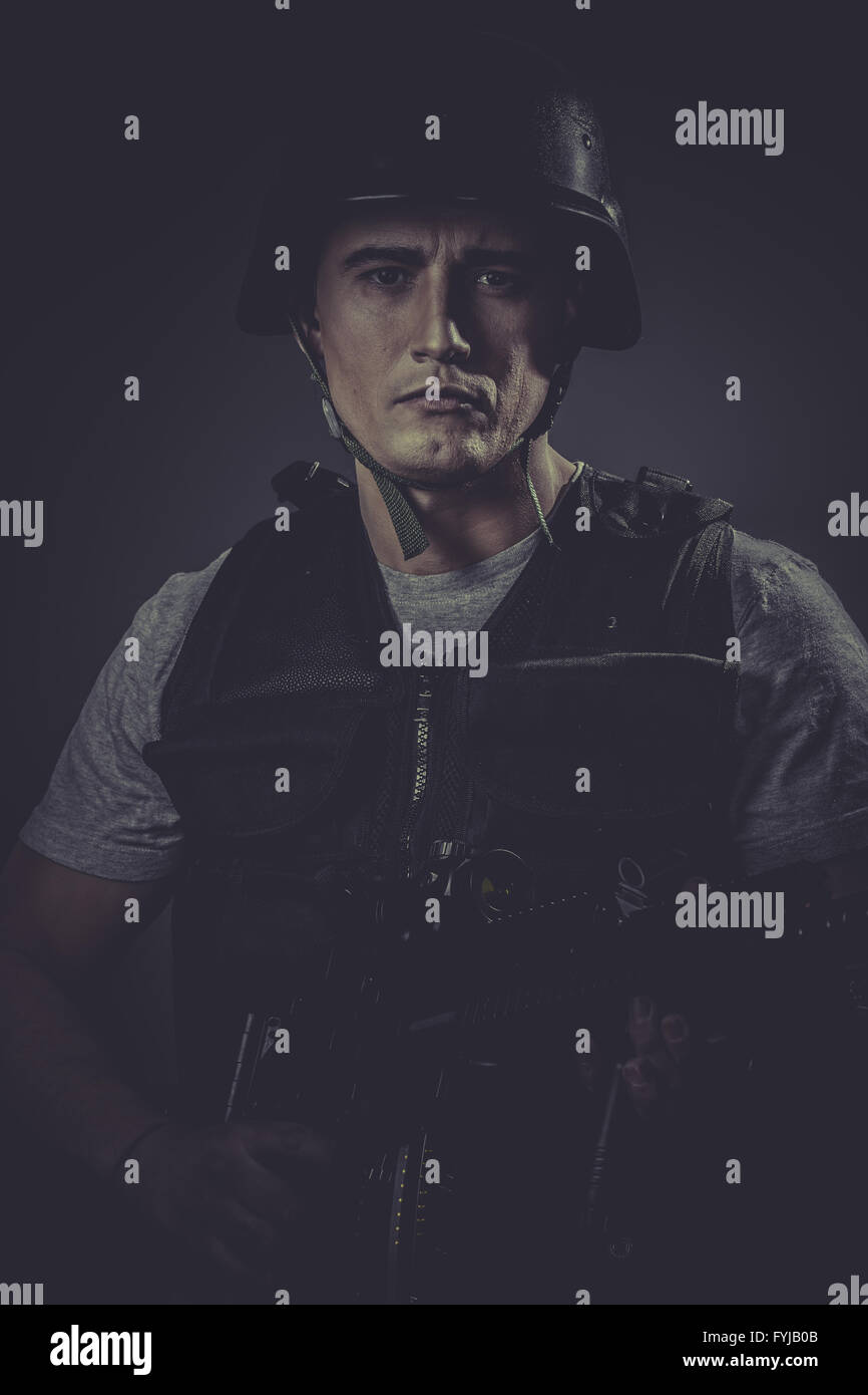 Uniform player wearing protective helmet aiming pistol ,black armor and ...