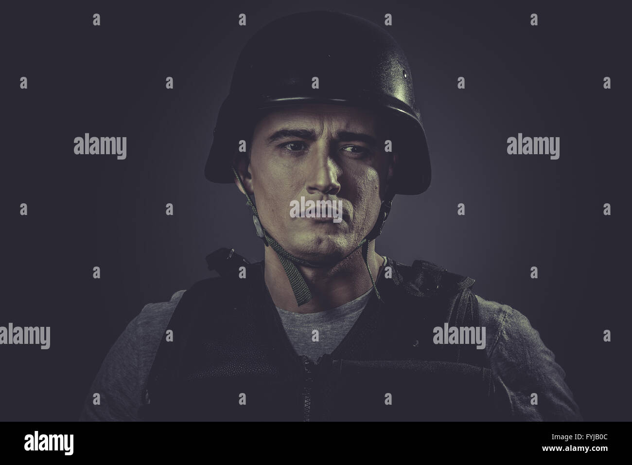 Security, paintball sport player wearing protective helmet aiming ...