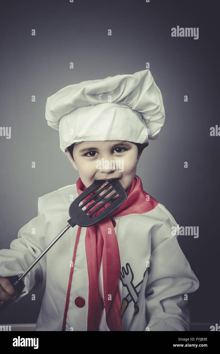 boy dressed as a cook with kitchen utensils Stock Photo - Alamy